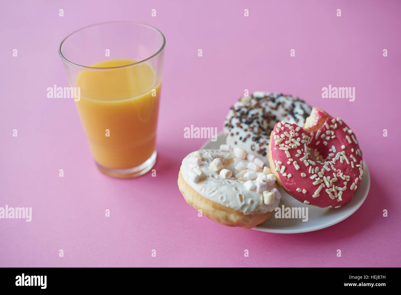Picture of glass with juice and donuts Stock Photo - Alamy