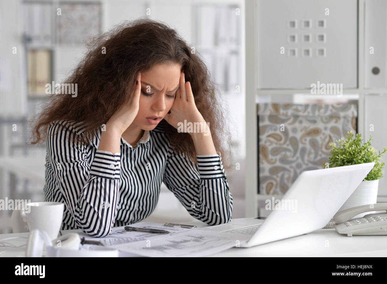 Tired woman with laptop Stock Photo - Alamy