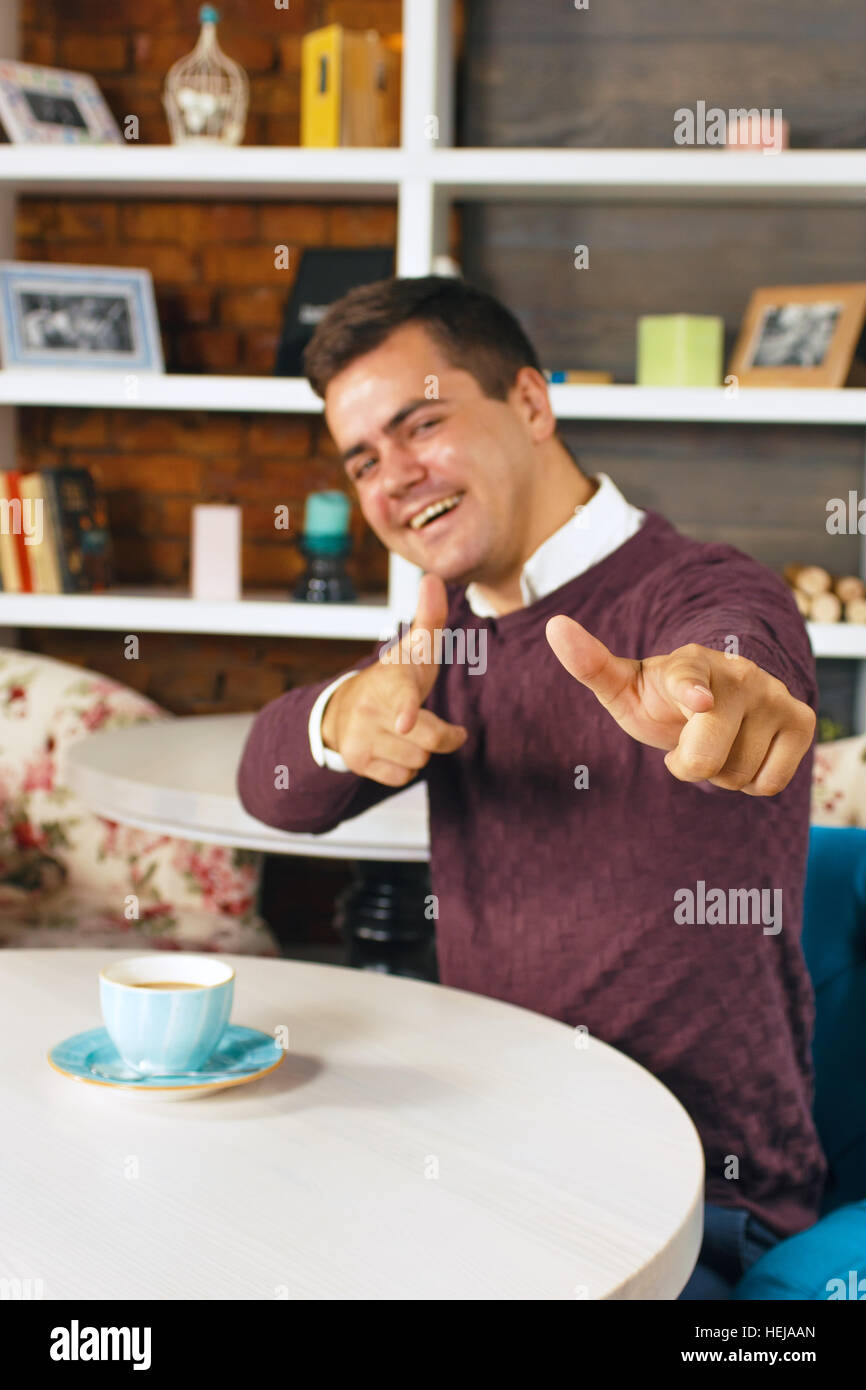 Young man smiling and pointing at you with both hands Stock Photo - Alamy