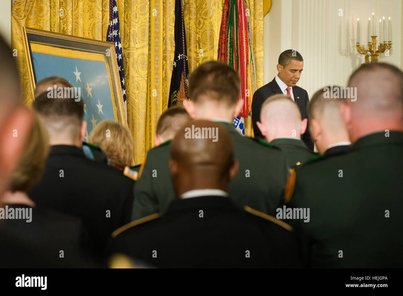 President Barack Obama bows his head in prayer at the beginning of the ...