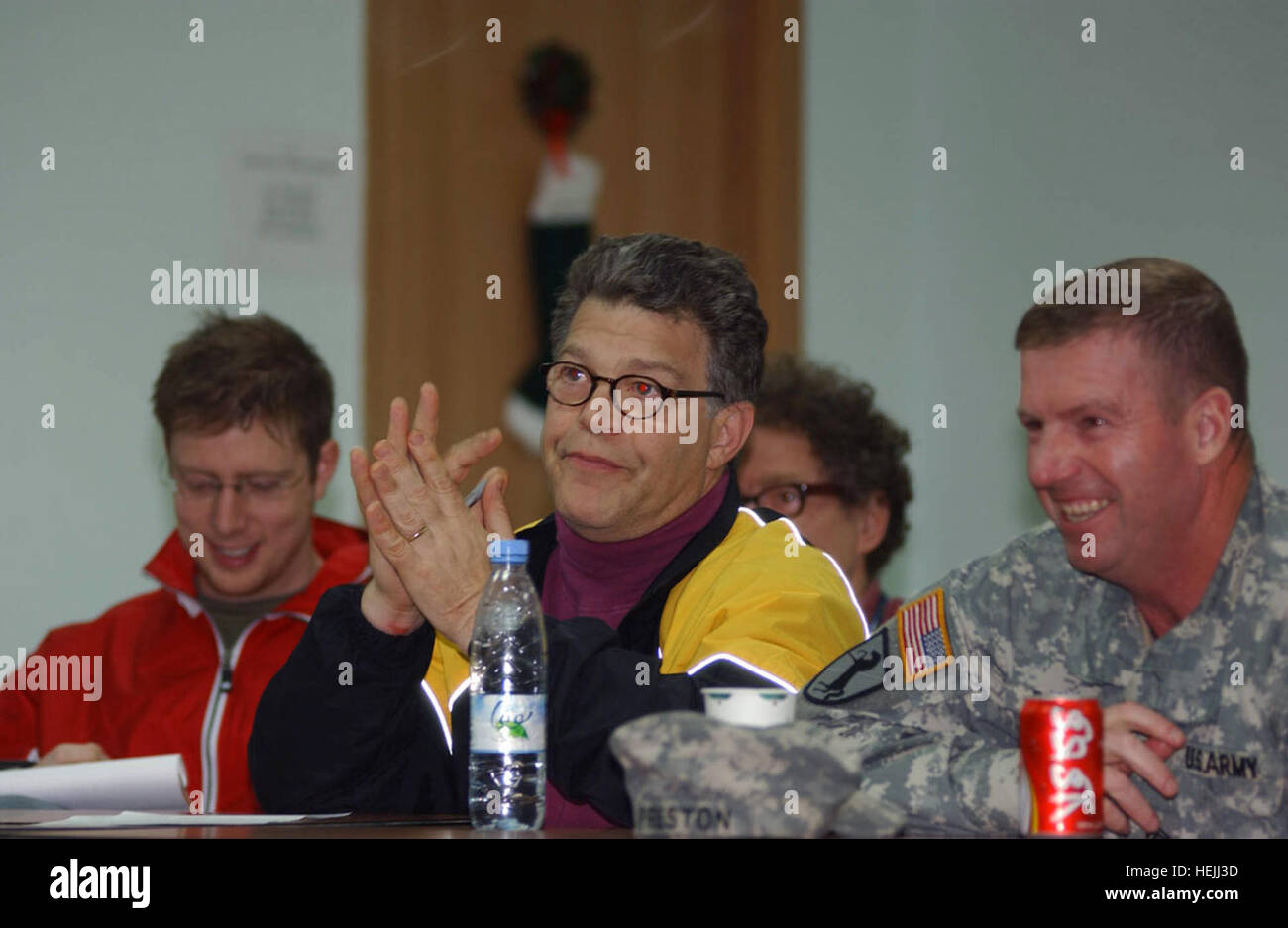 During a meet and greet with local Iraqis, Al Franken (center), draws a ...