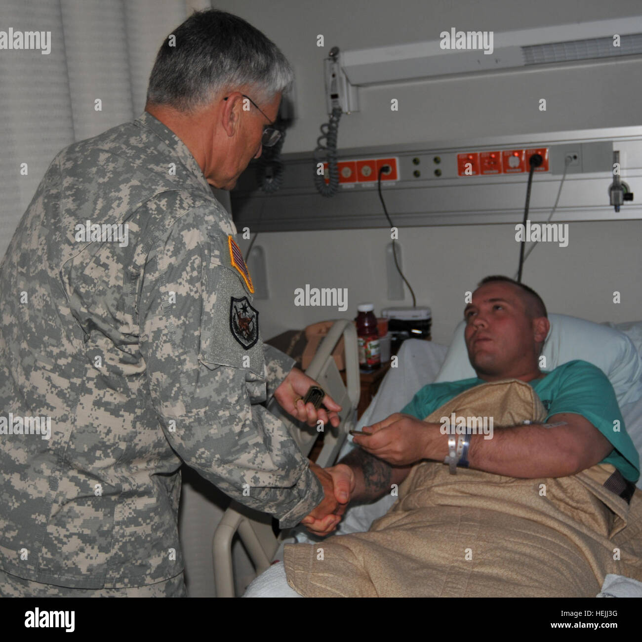 US Army 51651 Marine Staff Sgt. Tyler A. Gump receives a coin from ...