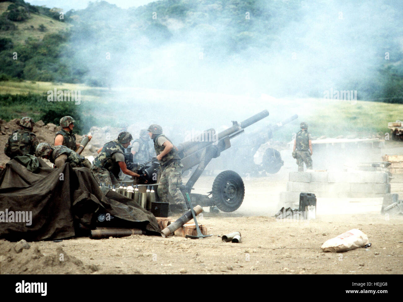 82nd Airborne artillery personnel load and fire M102 105 mm howitzers ...