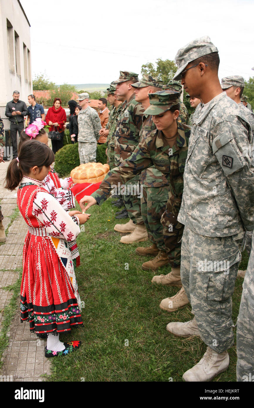 Local children give homemade bread and seasoning to members of the ...