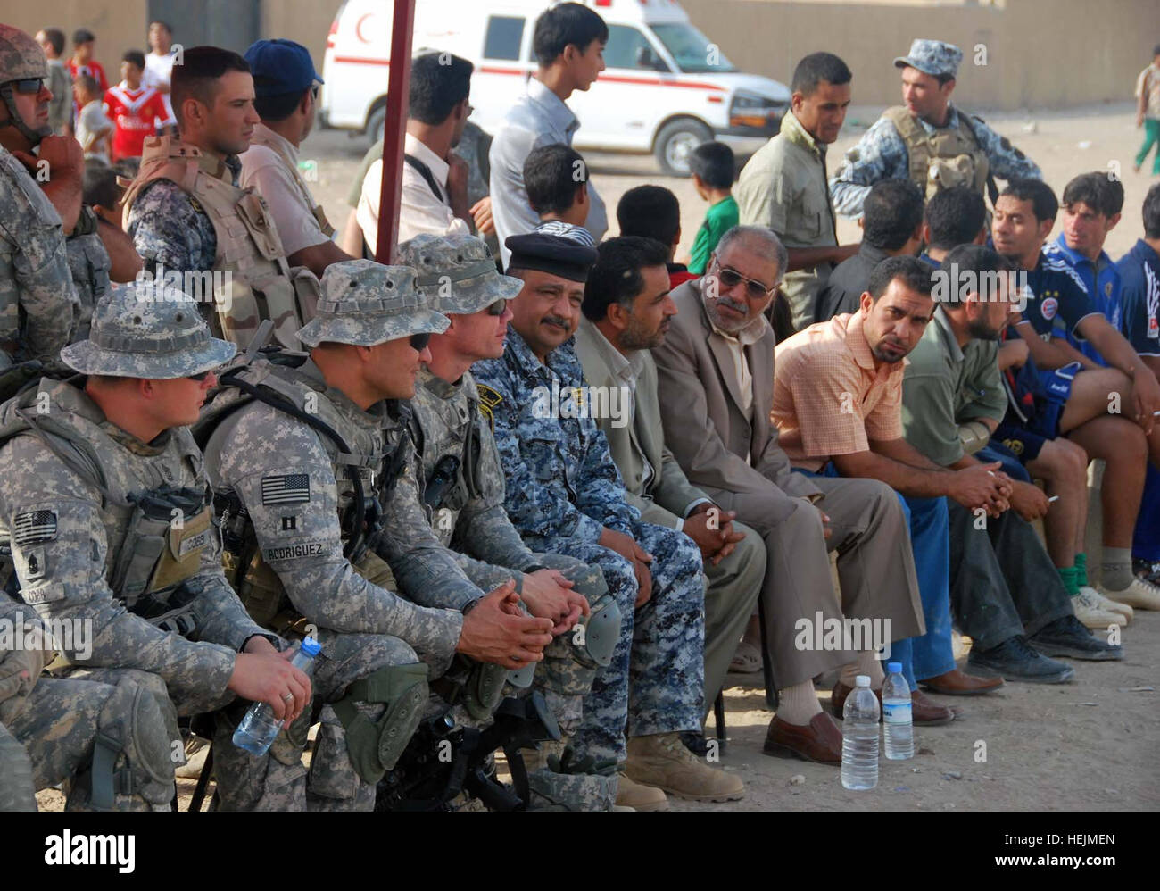 U.S. Army Soldiers and local Iraqi leaders observe a community soccer ...