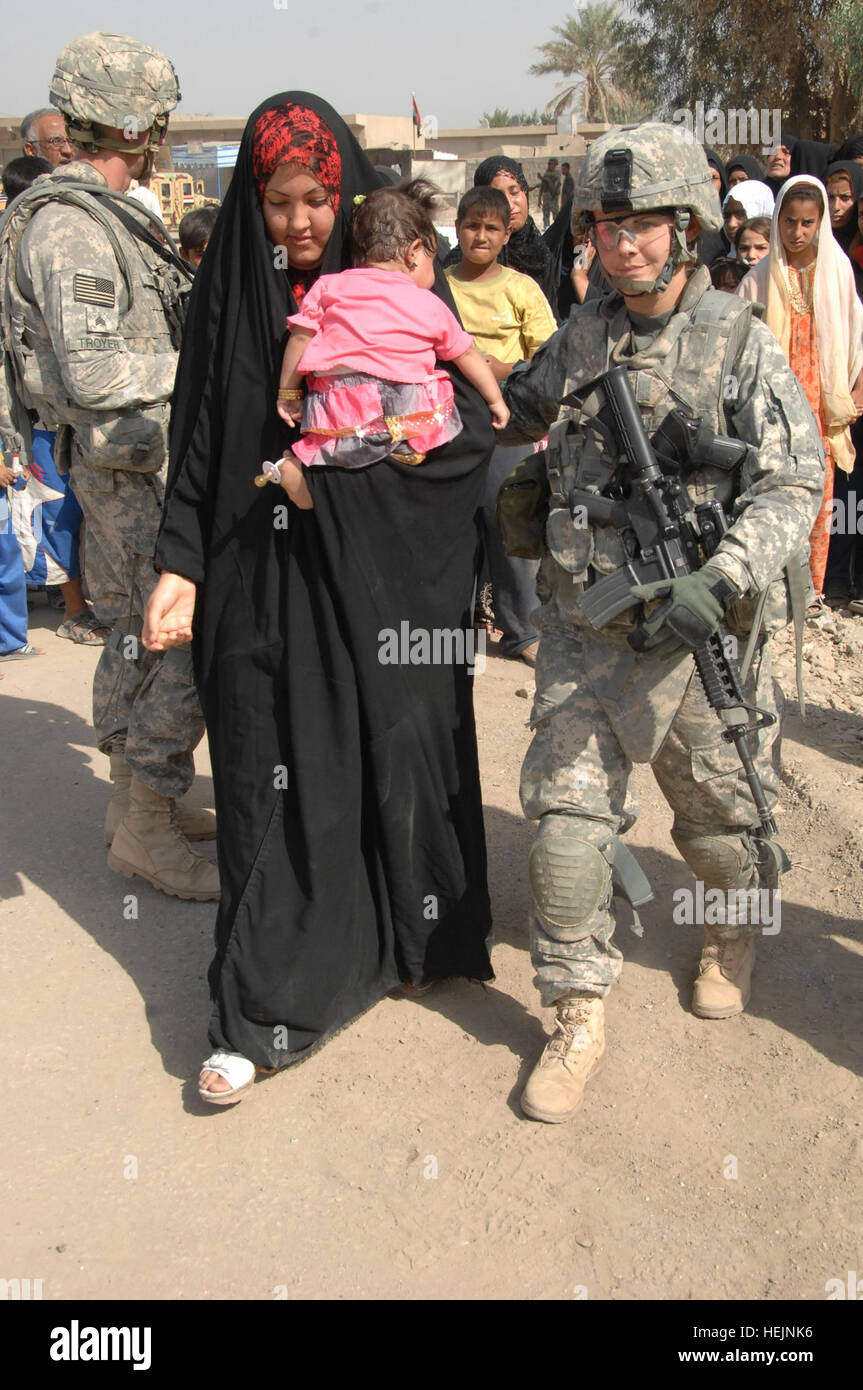 U.S. Army medics from the 82nd Airborne Division assist Iraqi medical ...