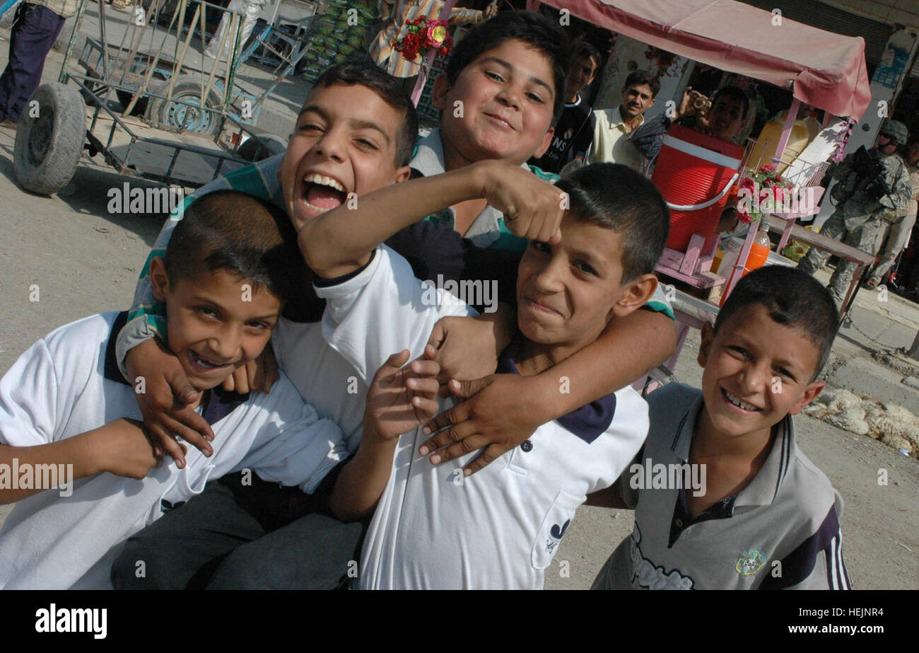 Children from Baqouba, Iraq, pose while Coalition Forces from 3rd ...