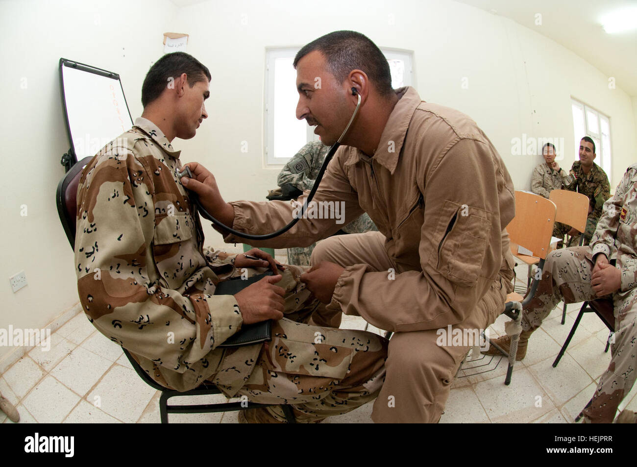 An Iraqi medic with the Camp Mejid Medical Clinic checks the vitals of ...