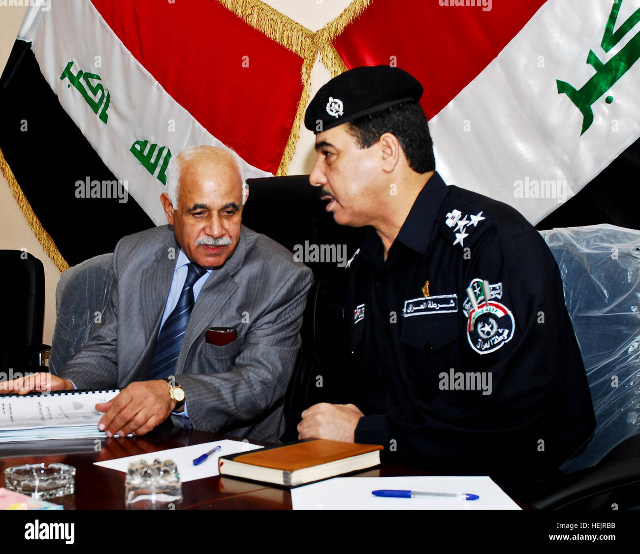 Iraqi police and judicial officials engage in discussions during a law ...