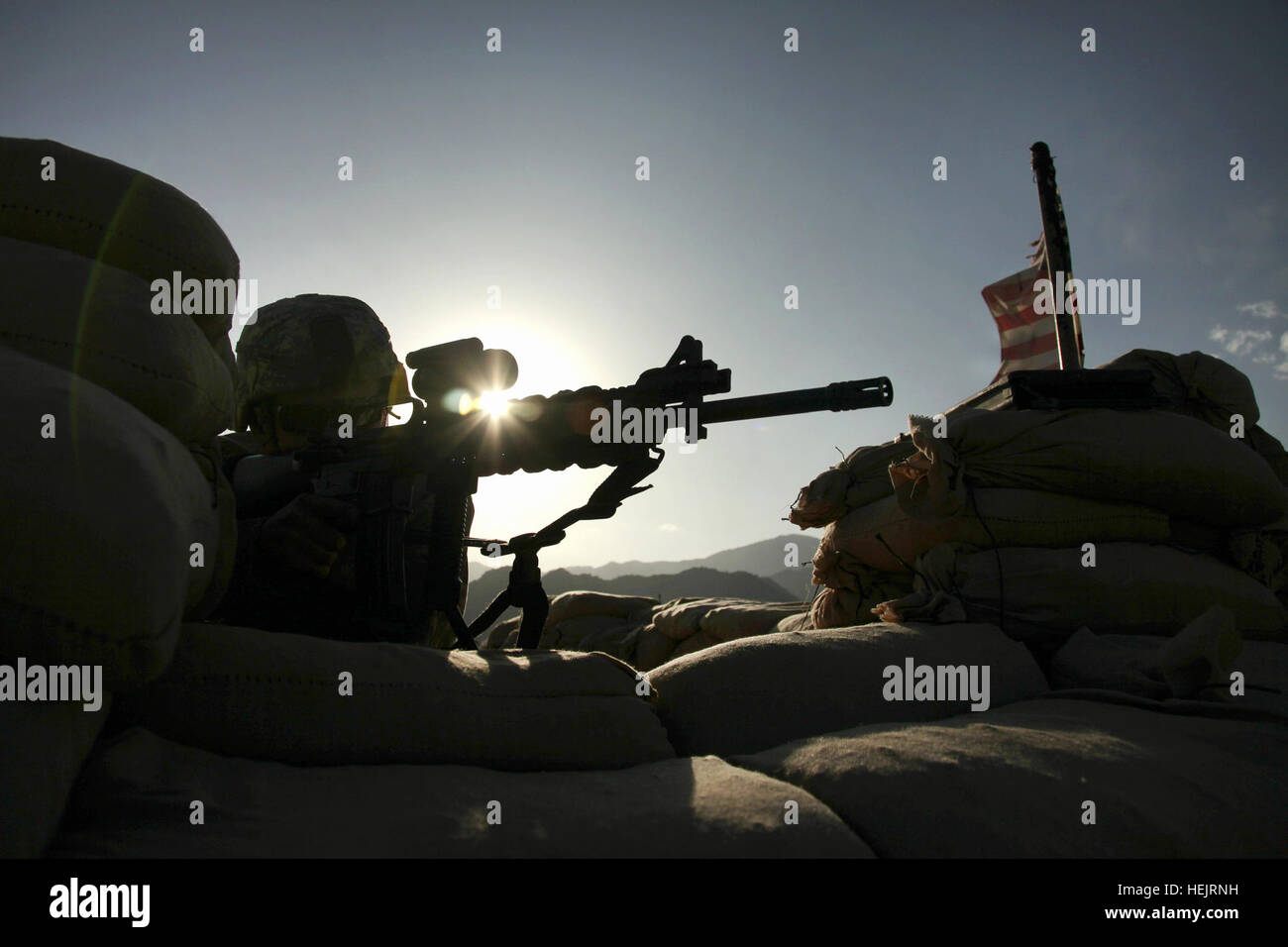 U.S. Army Staff Sgt. Calvin Esslinger scans a ridgeline from an ...