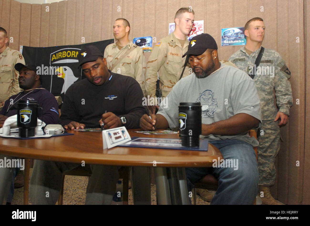 Soldiers wait behind Keith Byars and Bryan Cox for an opportunity to ...