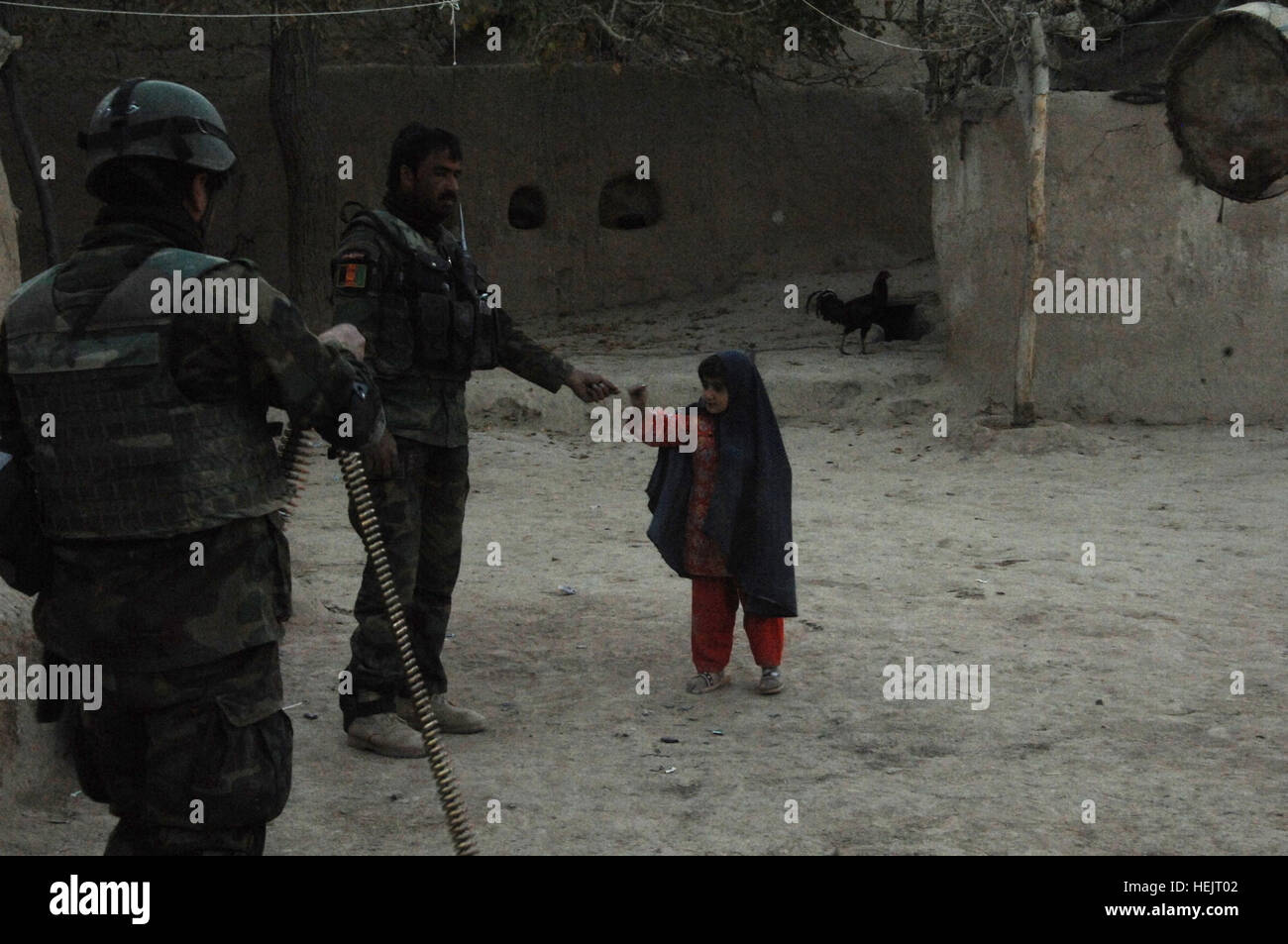 A local Afghan child is given food by an Afghan commando during a ...