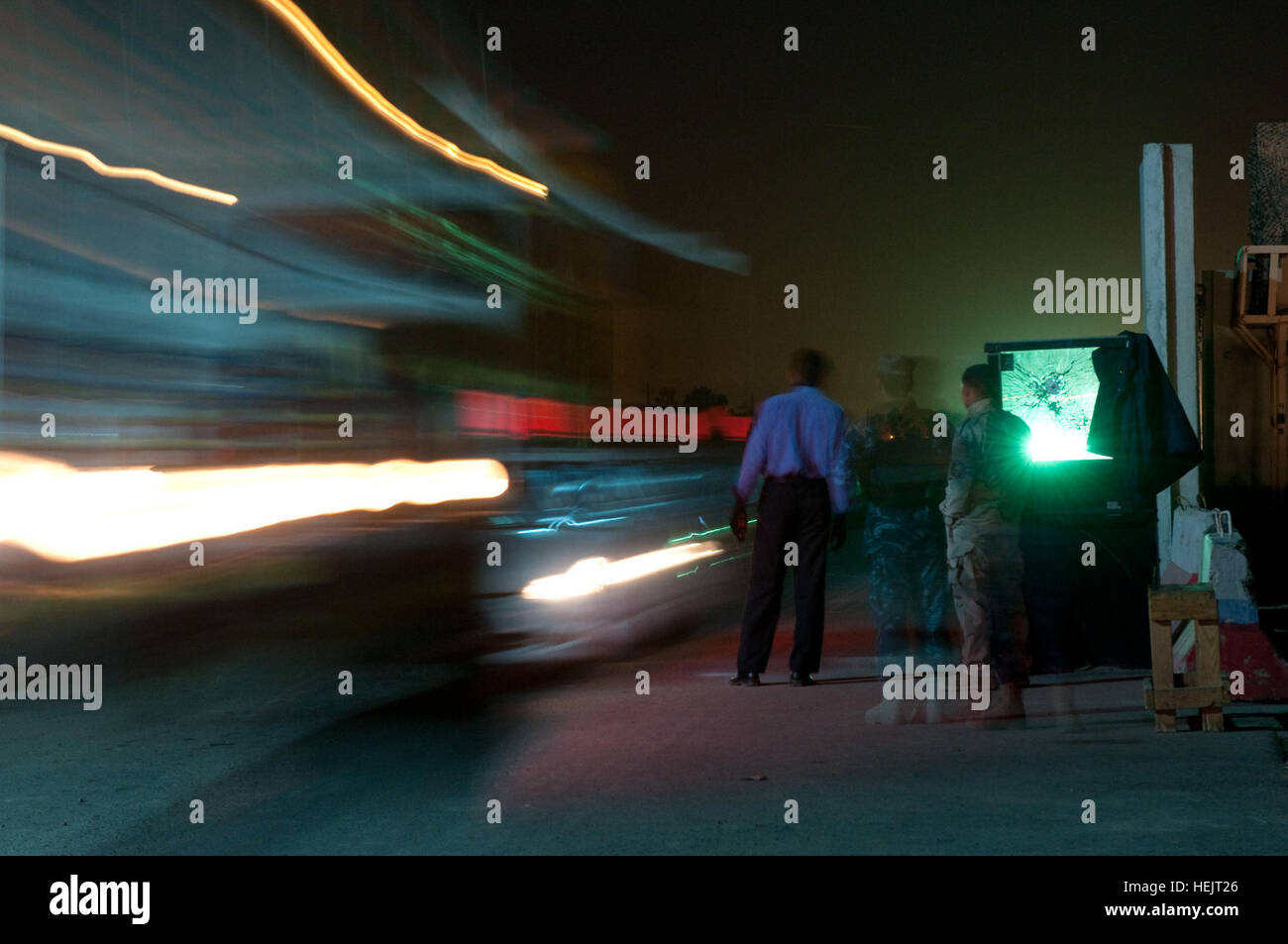 Nighttime traffic passes members of Iraqi police, provincial security ...