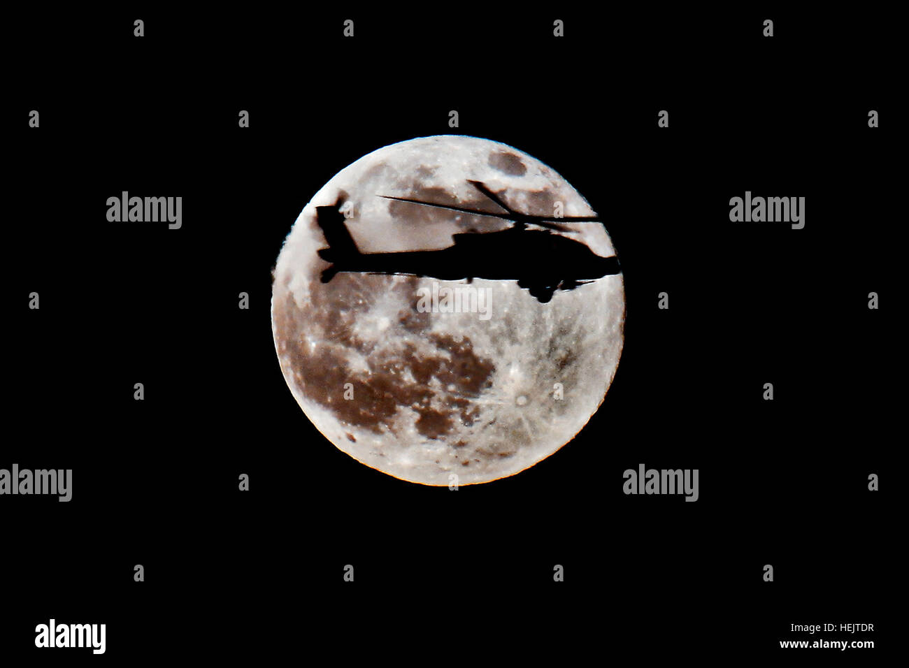 Under the cover of night, an AH-64D Apache attack helicopter from the ...