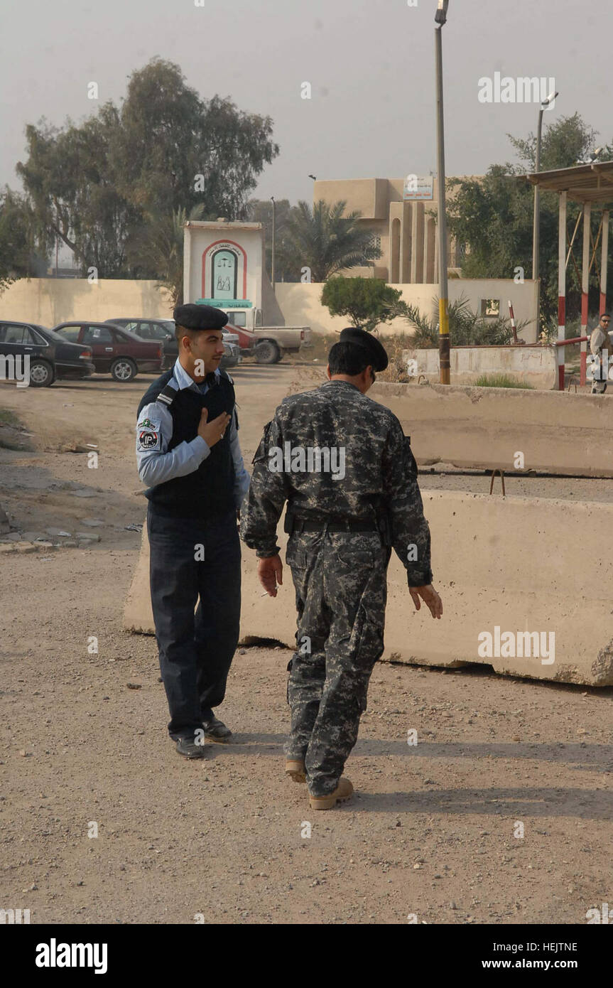 An Iraqi policeman greets an Iraqi national police general during a ...