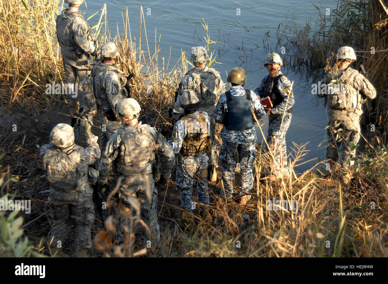 U.S. and Iraqi Army personnel conduct a cordon and search operation ...