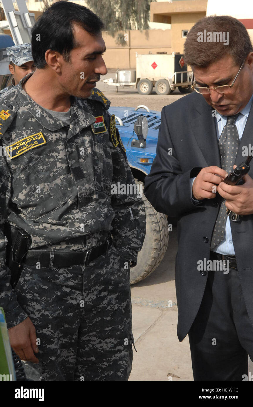 An Iraqi National Police general speaks with a local Iraqi official ...