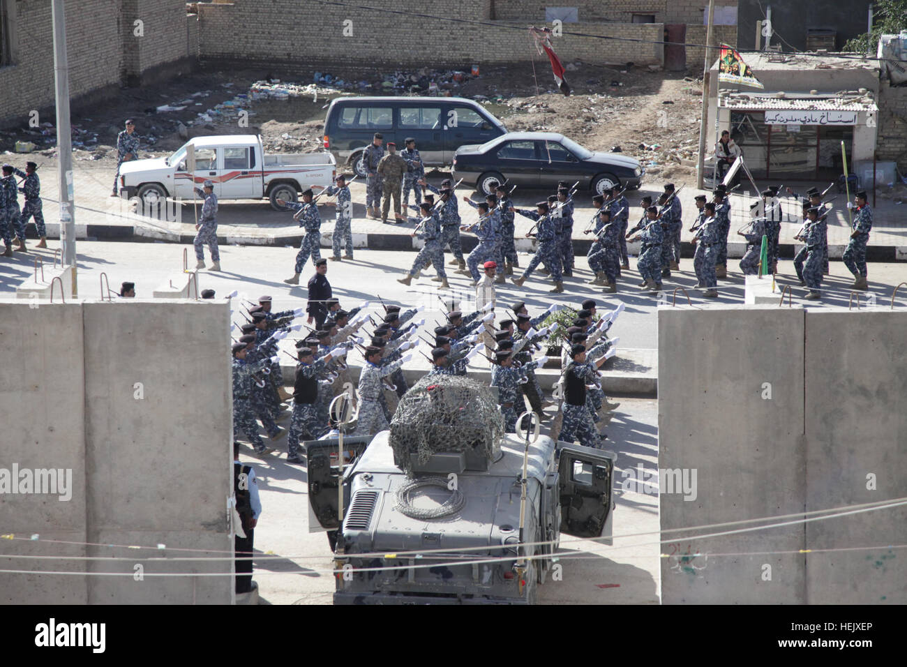 Iraqi police officers march on the street behind the Provincial Joint ...
