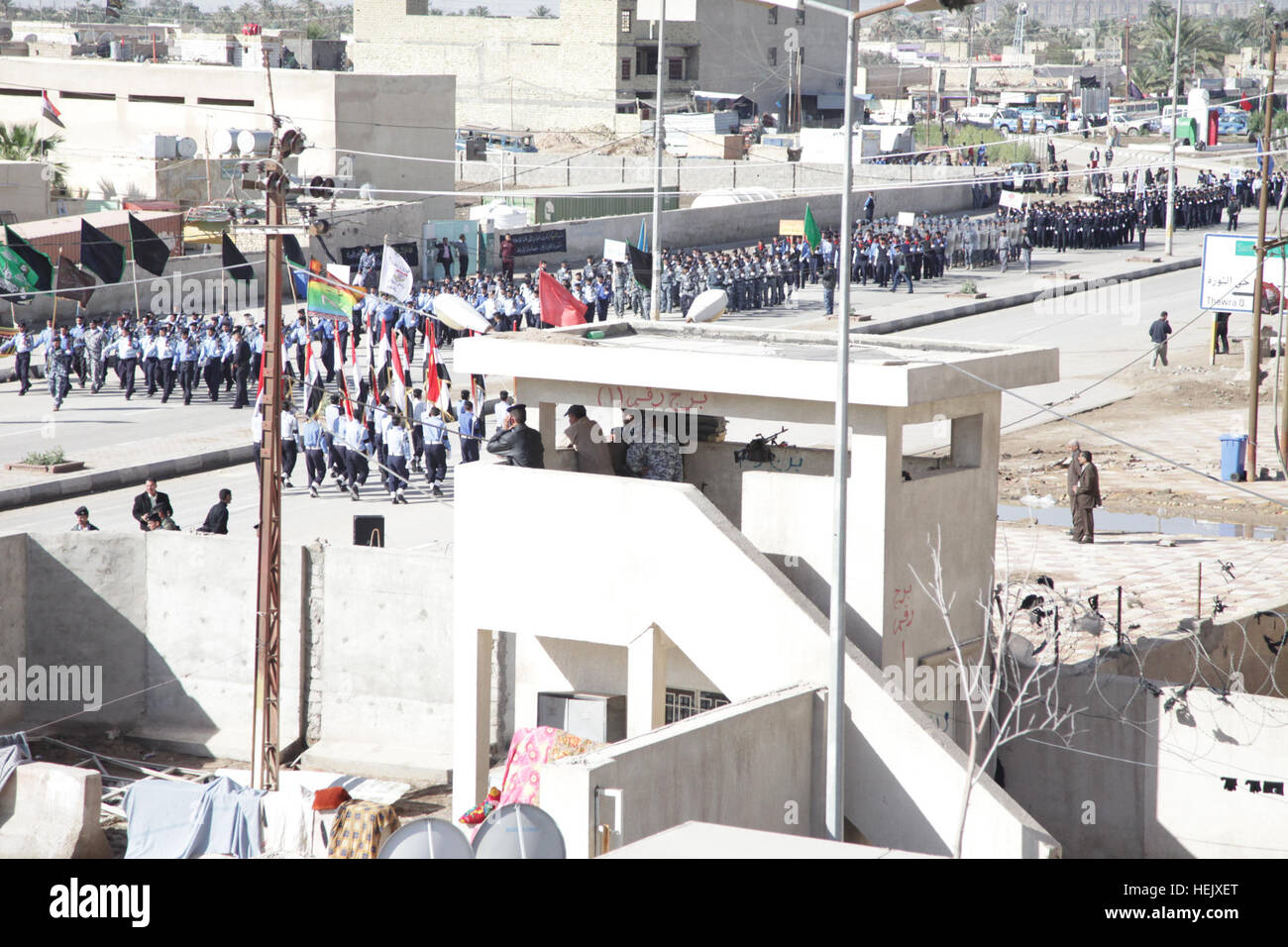 Iraqi police officers march on the street behind the Provincial Joint ...