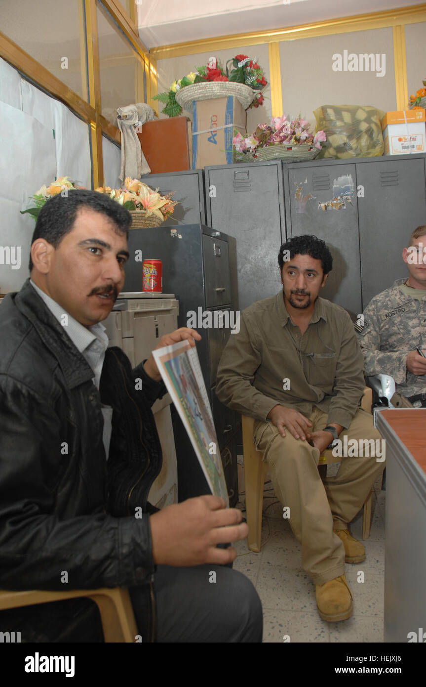 A member of the Dhi Qar Police media cell speaks with U.S. Soldiers ...