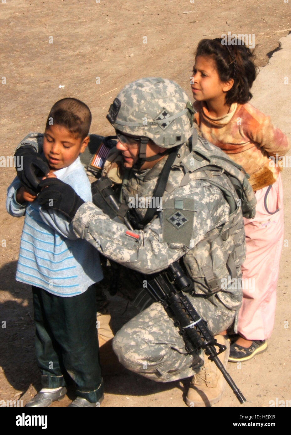 Teaching an Iraqi child the peace sign. CONTINGENCY OPERATING BASE ...