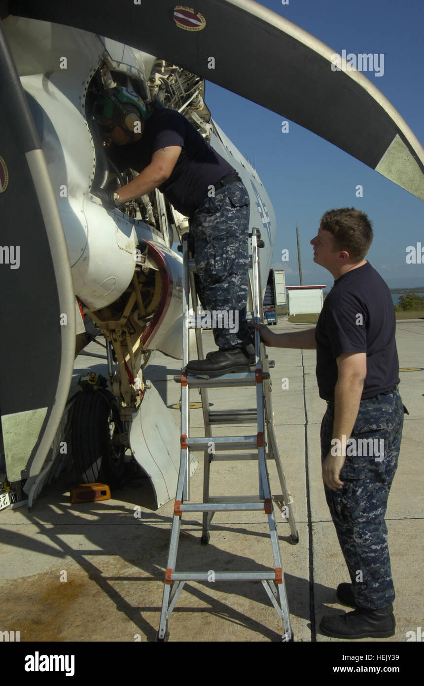 Maintenance personnel conduct routine maintenance to a C-2A Greyhound ...