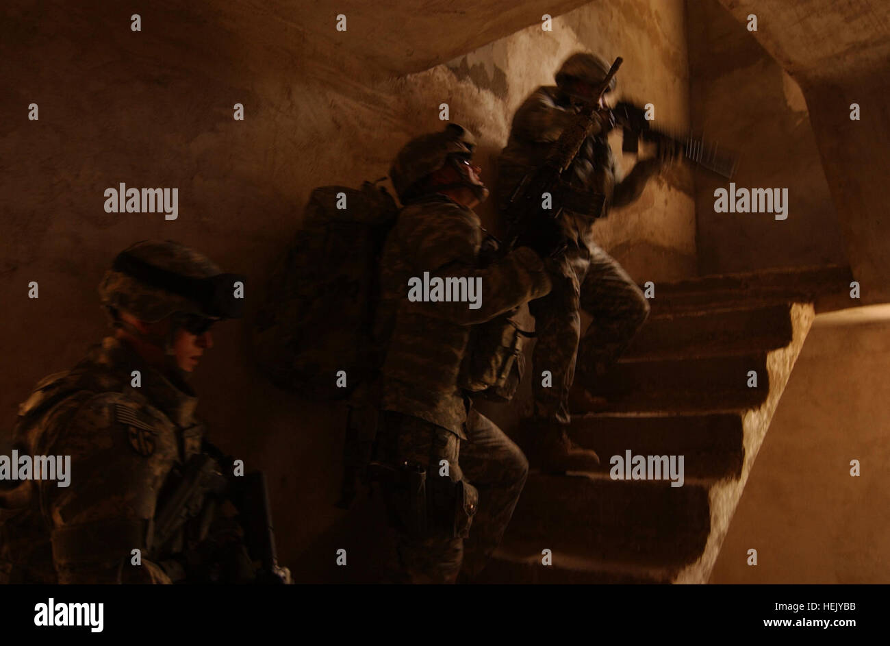 Military policemen and infantrymen clear a building during a raid in Al ...