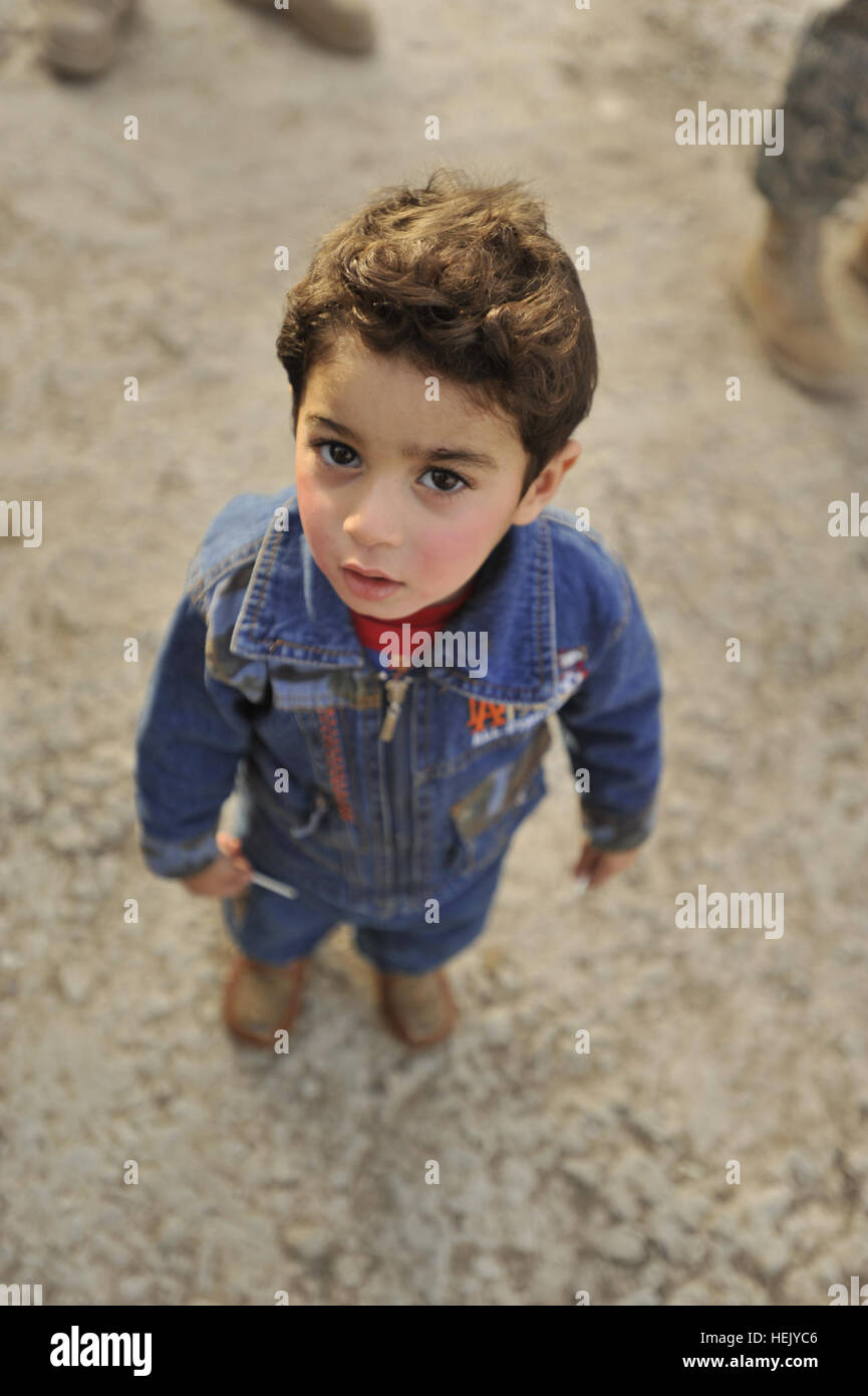 A young Iraqi boy mingles with U.S. Airmen from the 447th Air ...