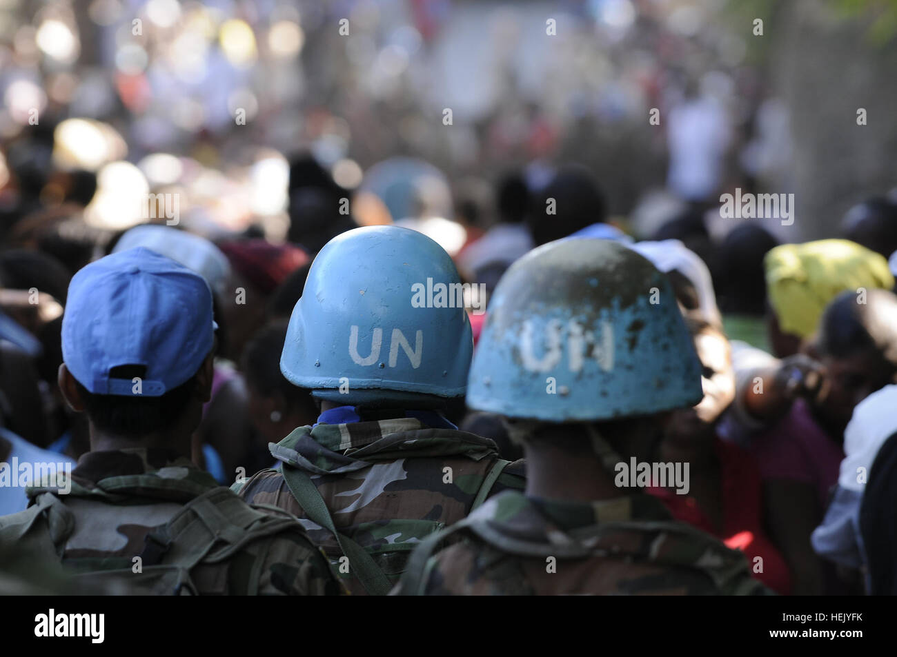 United Nations soldiers stand at the head of a crowd waiting in line ...