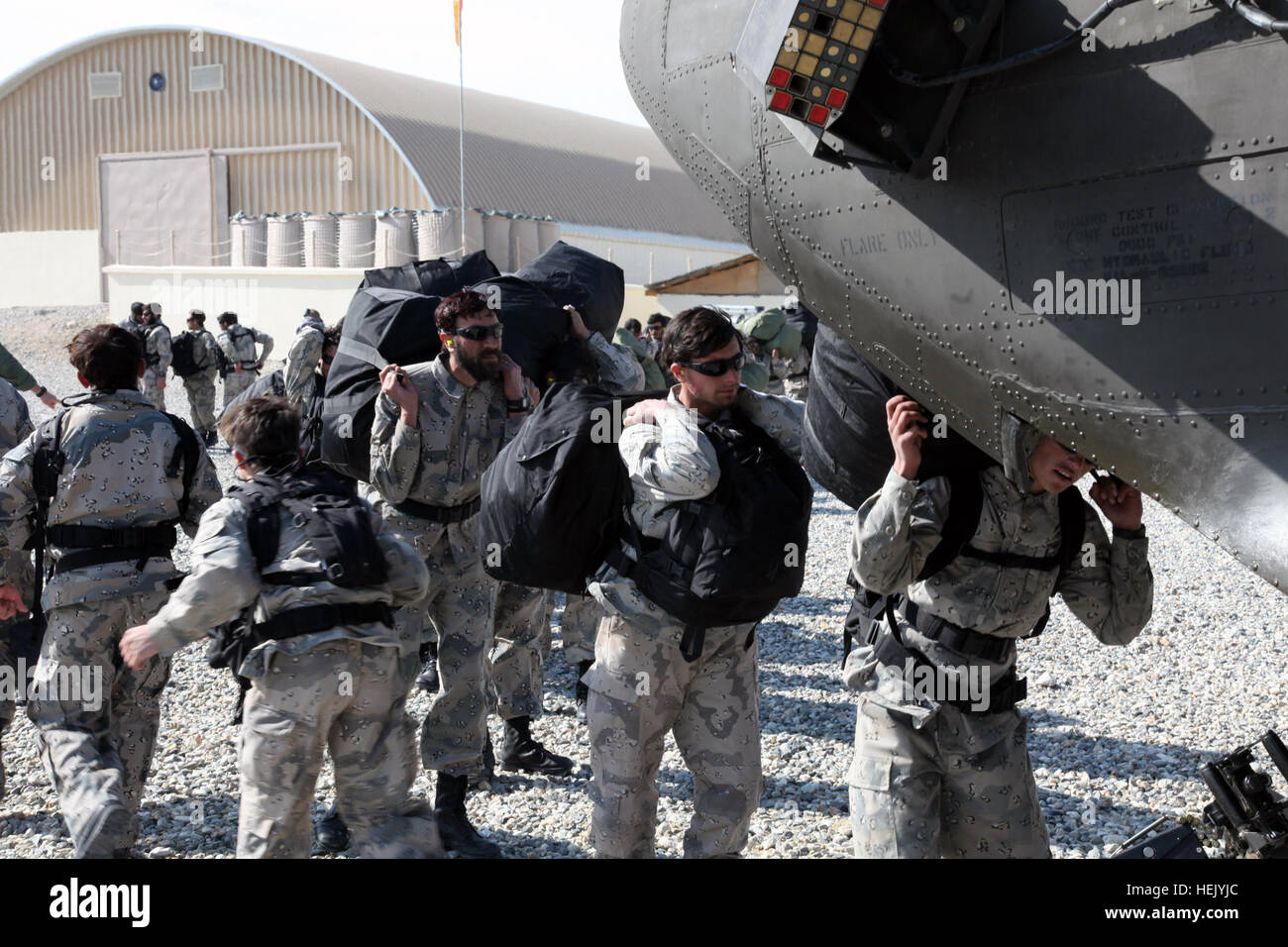Afghan border patrol troops move aboard a CH-47 Chinook helicopter in ...