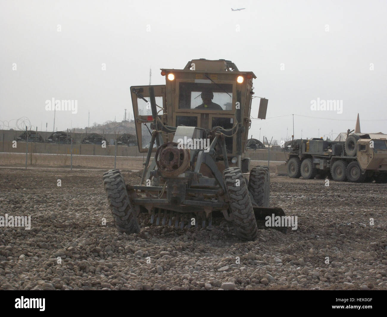 Spc. Bret Harmon, 317th Engineer Company, operates the 130G Grader at ...