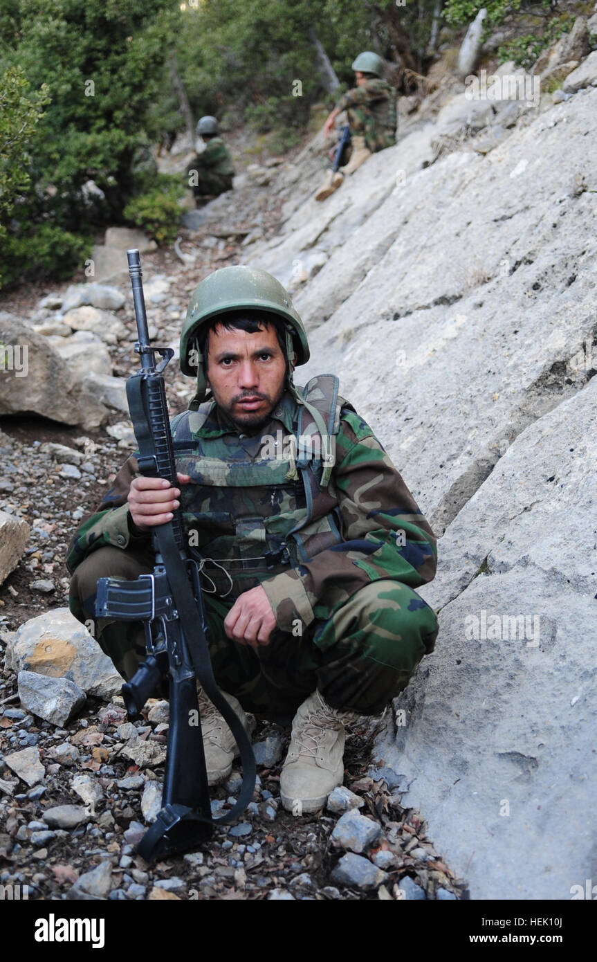 An Afghan National Army Soldier rest for a moment while on patrol ...