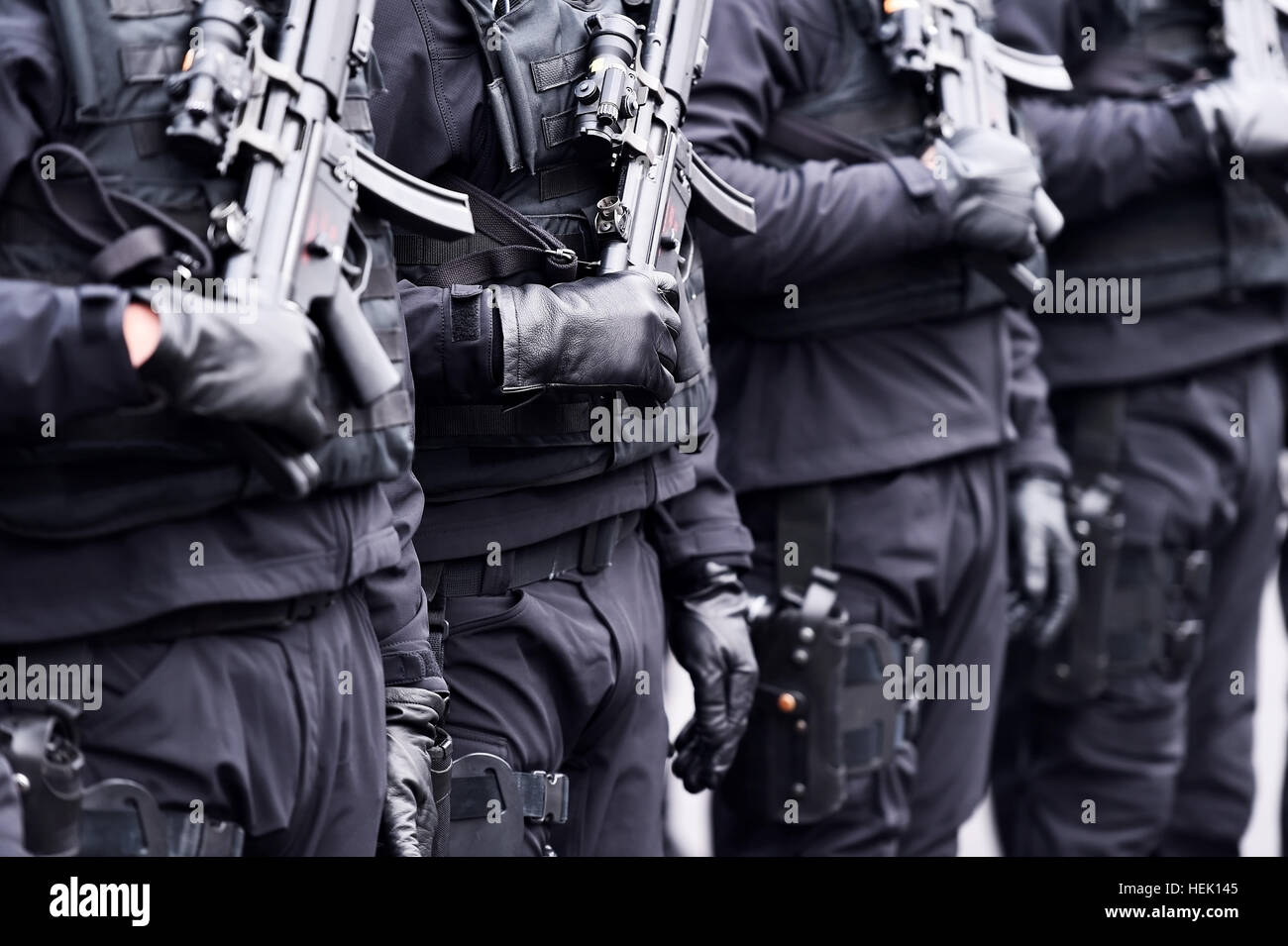 Soldier hand in black glove holding automatic machine gun during a ...
