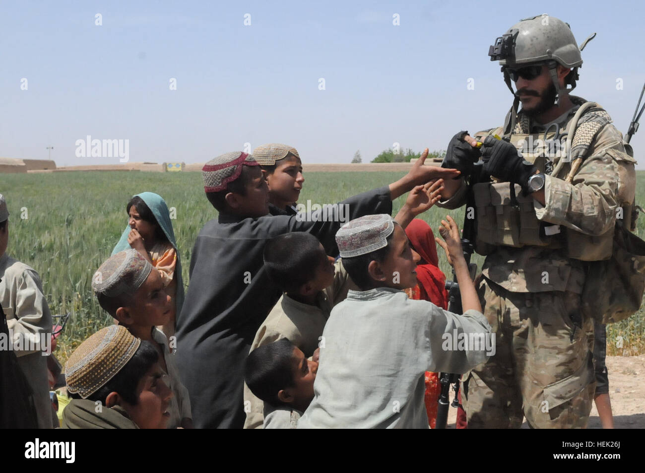 A United States Special Forces Soldier hands out water drink mix to ...