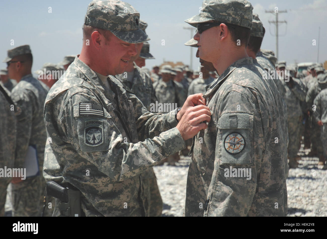 Navy Cmdr. Michael Elbert awards a Task Group Trident Sailor for his ...