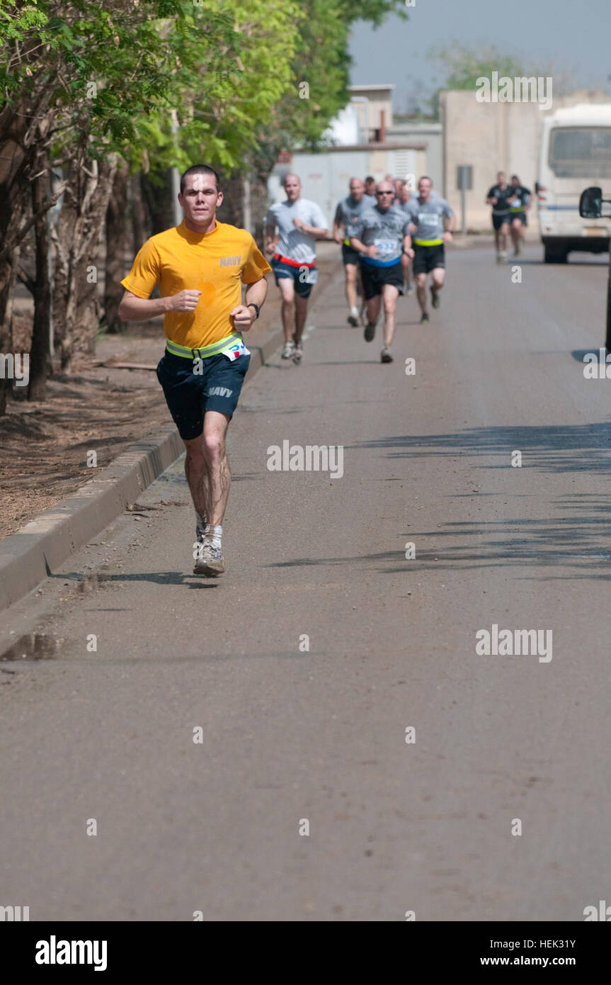 Service members and civilians at Camp Victory, Iraq, take part in the ...