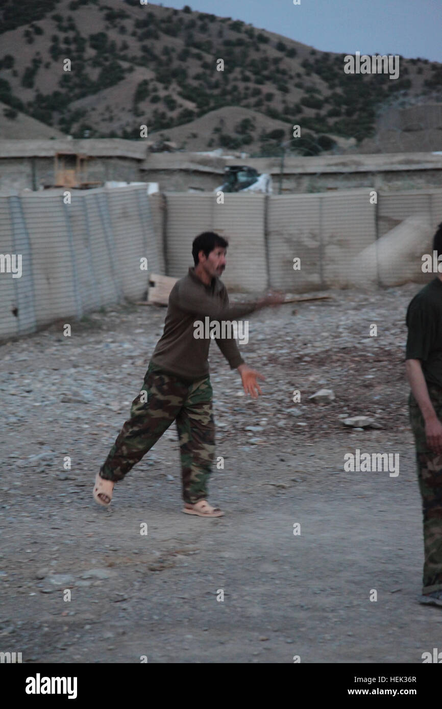 Afghan national army soldier serves the volleyball during a game held ...