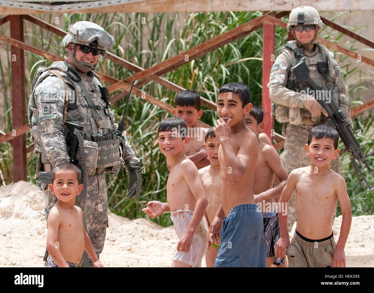 U.S. Army Sgt. 1st Class Jason Reininger is greeted by a group of local ...