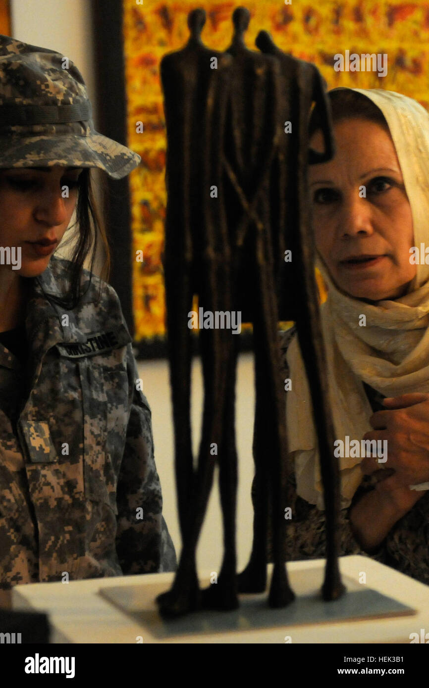 Women admire a sculpture created by a local Iraqi artist during the ...