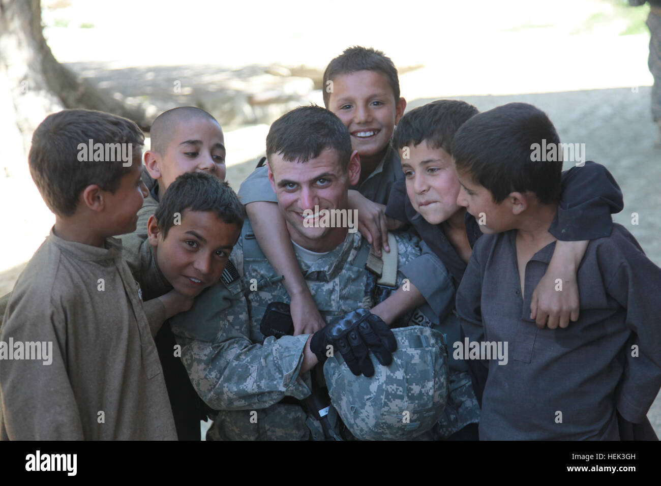 Afghan boys gather around a U.S. Army Soldier for a picture while talks ...