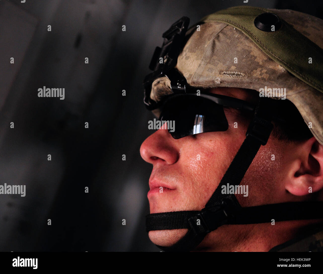 Army Reserve Cpl. Sean Brown looks out a window while pulling security ...
