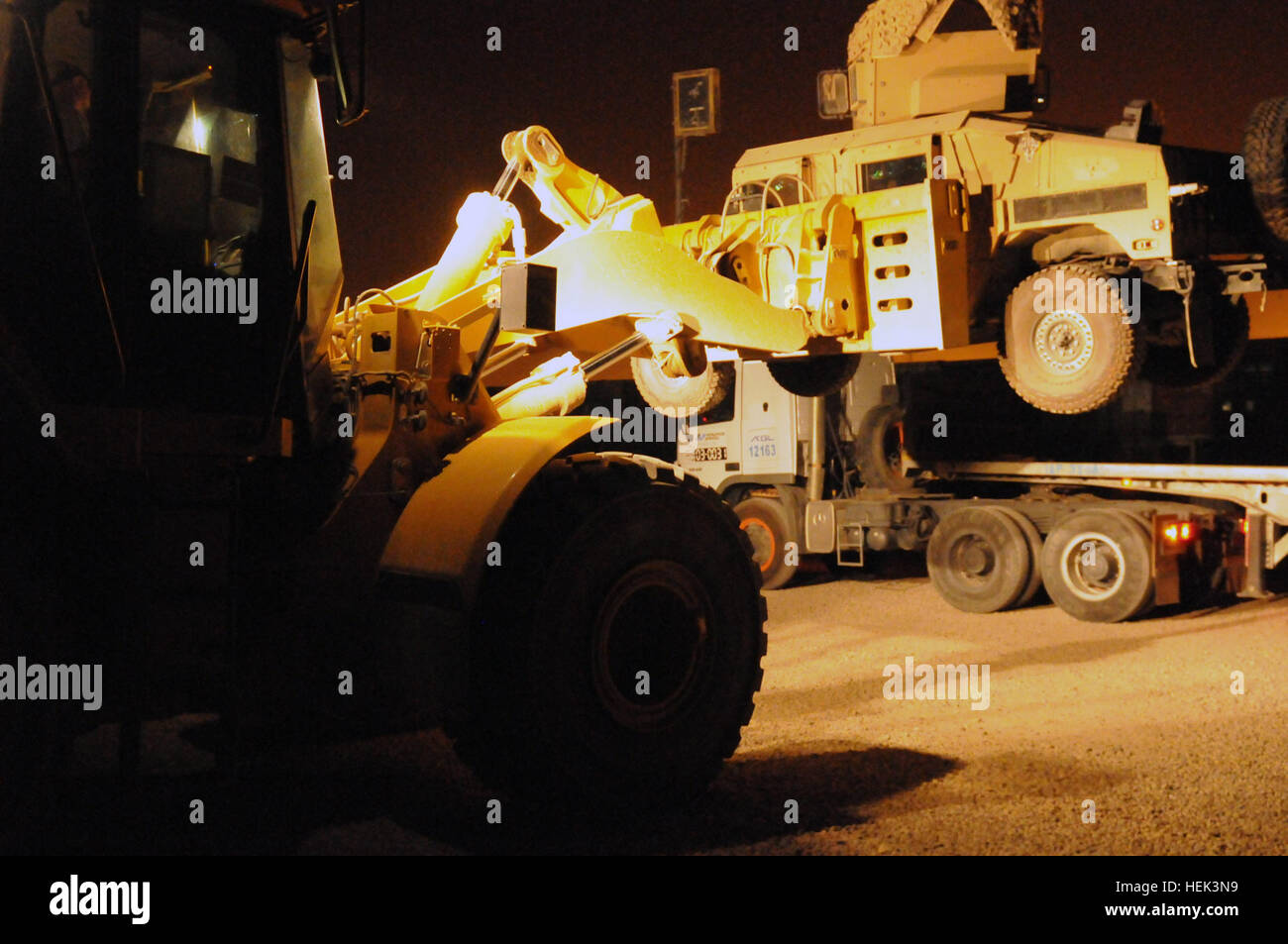 A forklift operator maneuvers a Humvee onto a semitrailer May 31 at ...