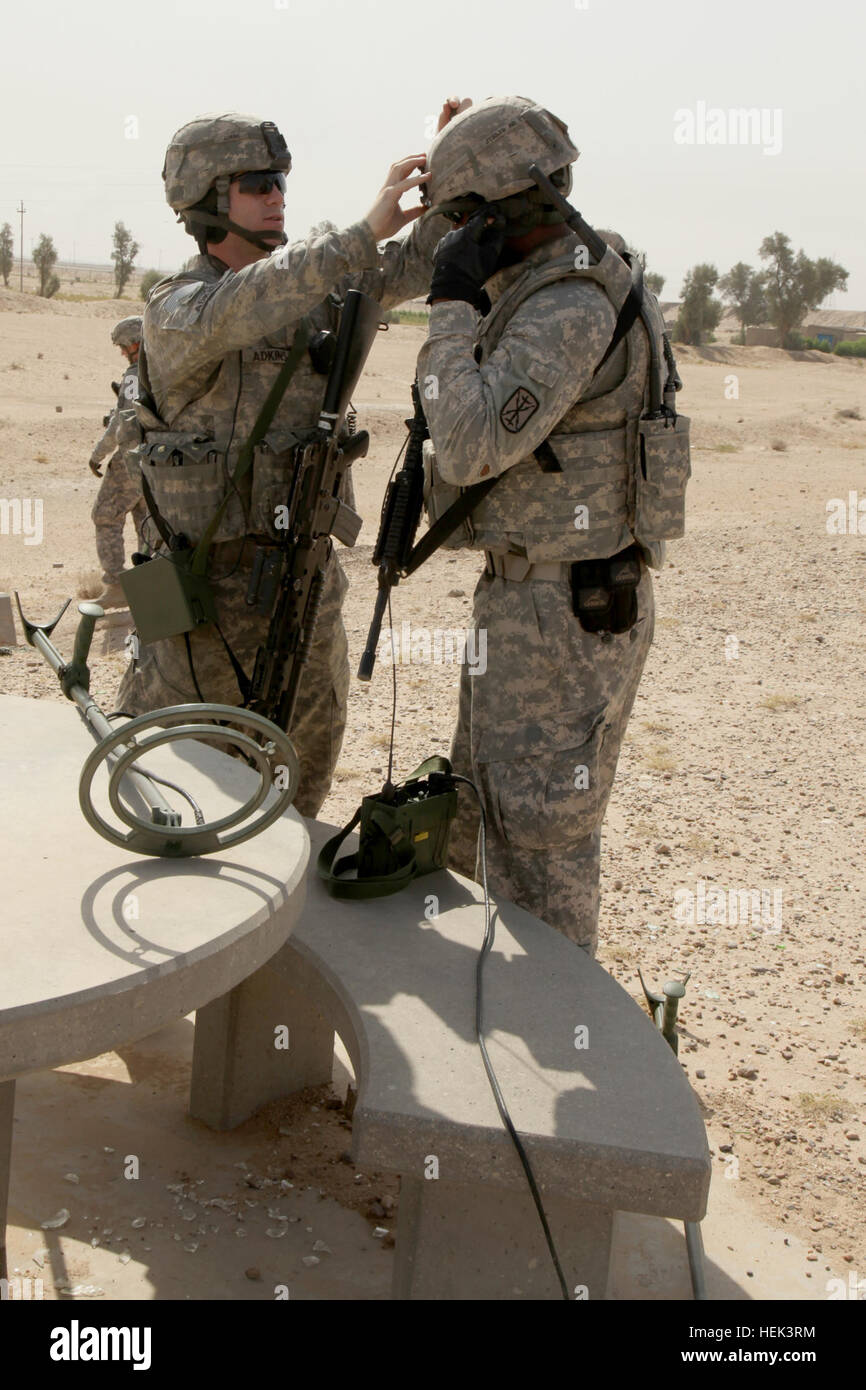 U.S. Army Sgt. Joshua Adkins from Williamsville, N.Y., helps Spc ...