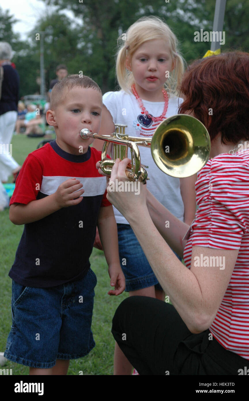 A little boy plays with a trumpet at an instrument zoo prior to the ...
