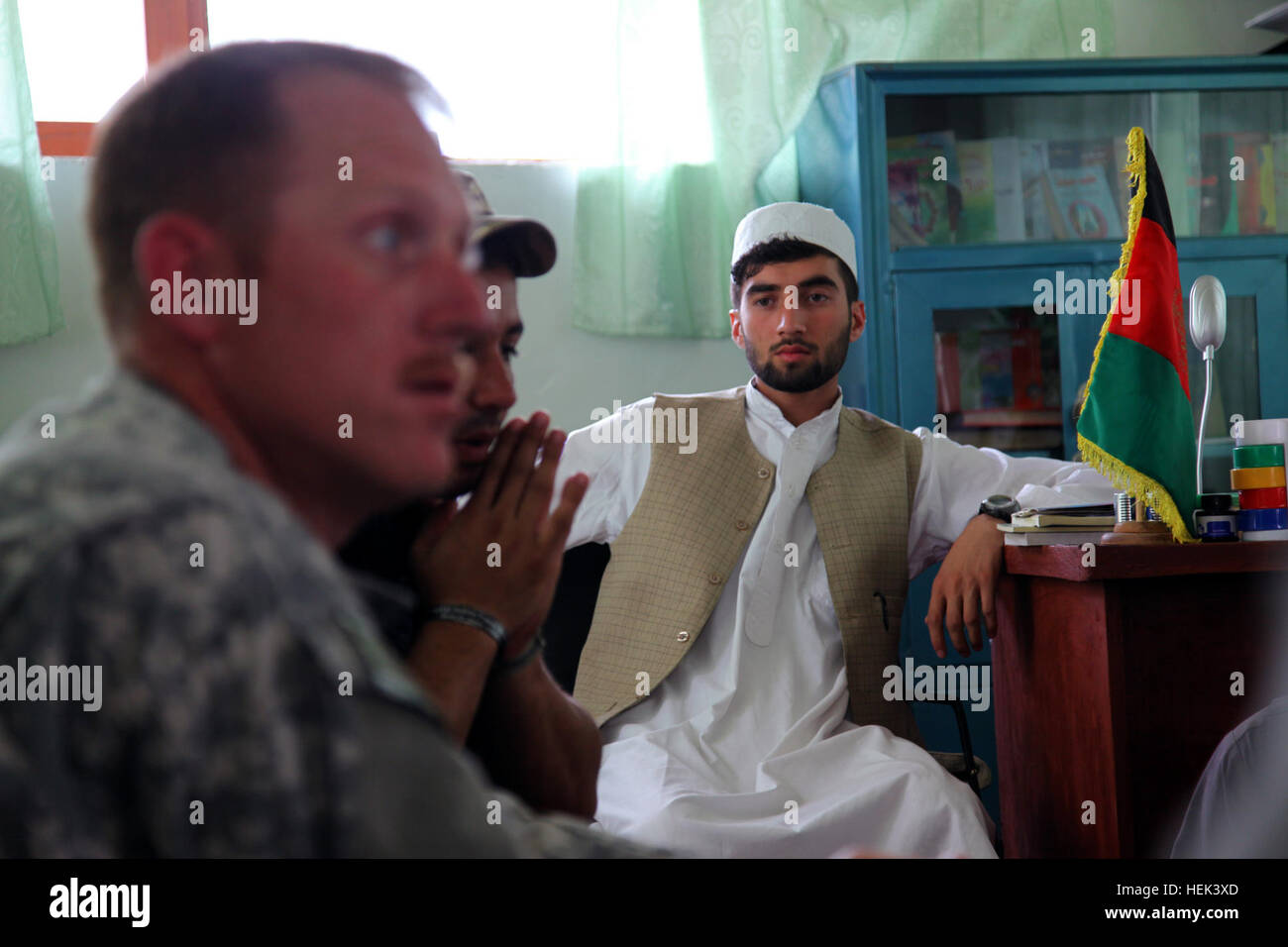 A local vendor listens to U.S Army Soldiers from Task Force Wolverine ...