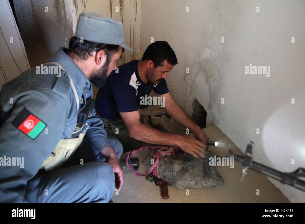 Afghan National Security forces pull weapons from a cache while U.S ...