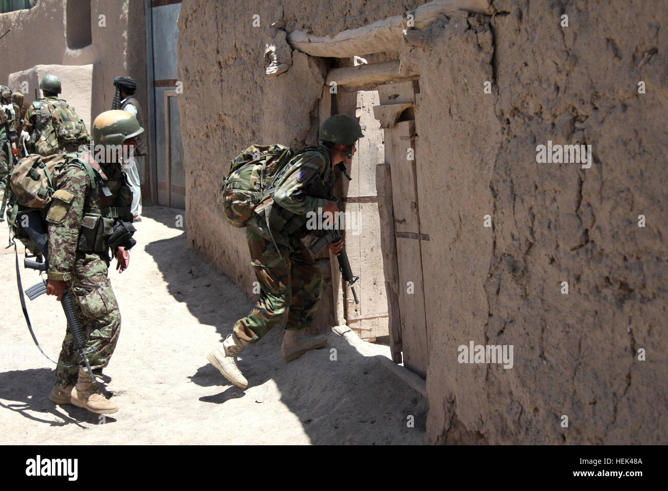Afghan National Army Soldiers enter a qalat to search for weapons ...