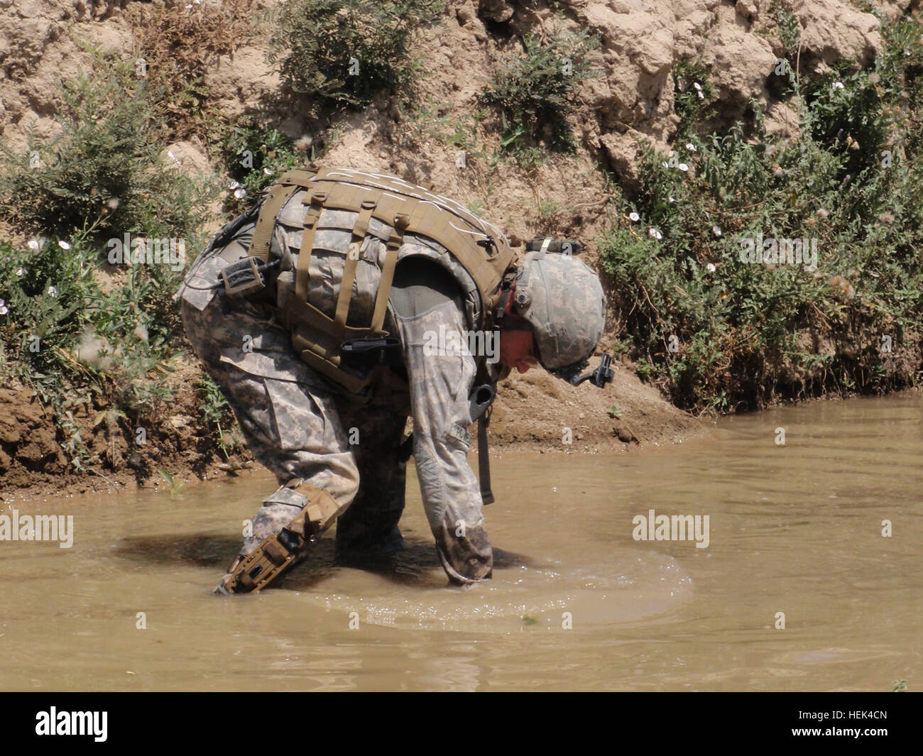 A U.S. Army member of a Counter Improvised Explosive Device Team combs ...
