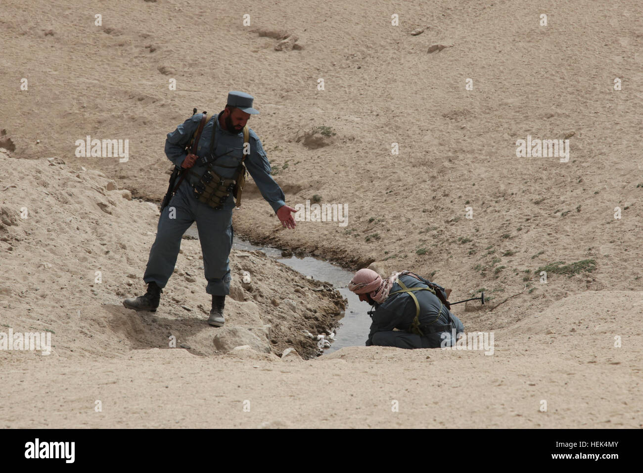 Afghan National Police officers stop for a drink of water while ...