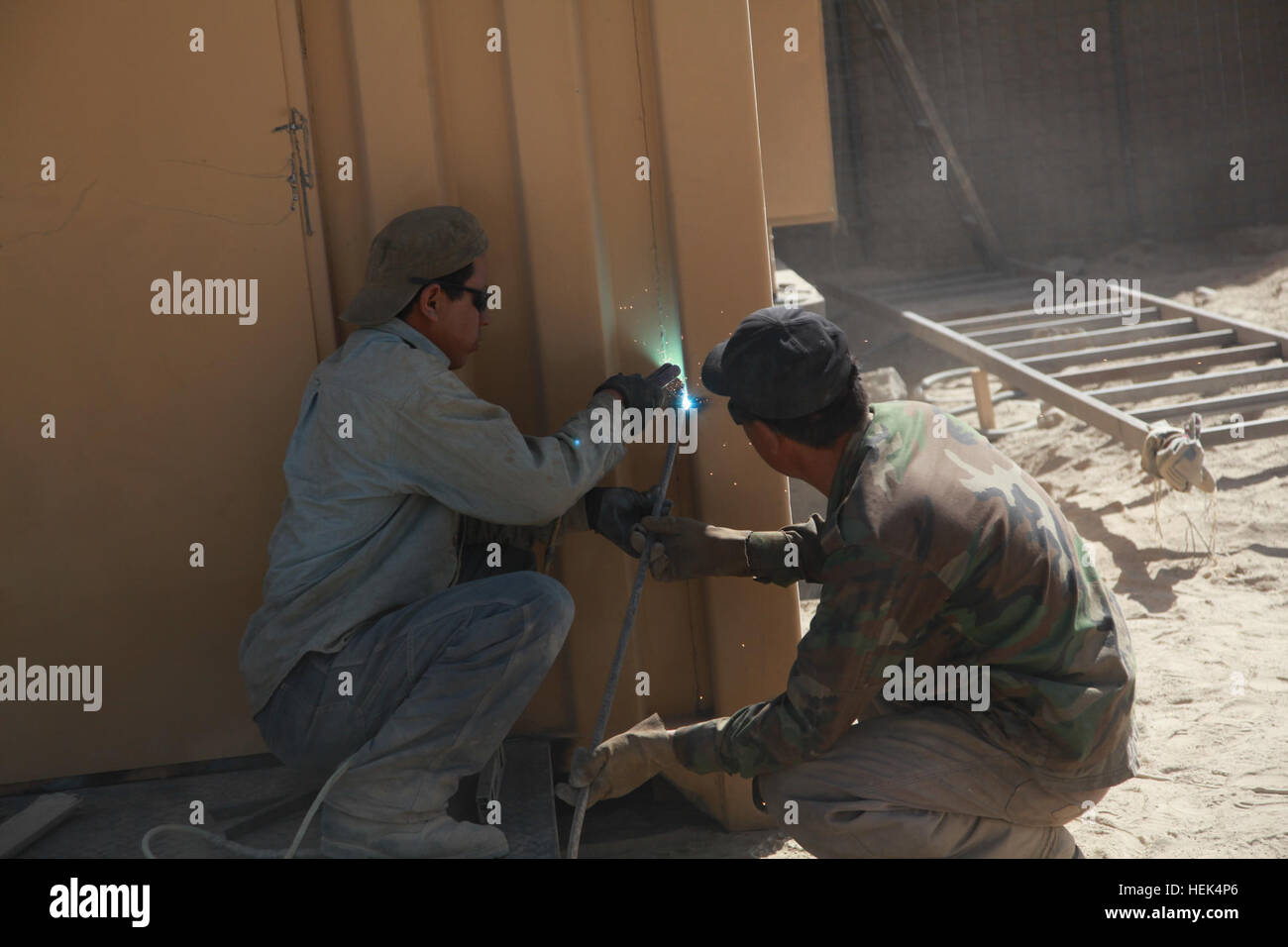 Afghan men weld a rod onto a container box at the Joint Combat ...